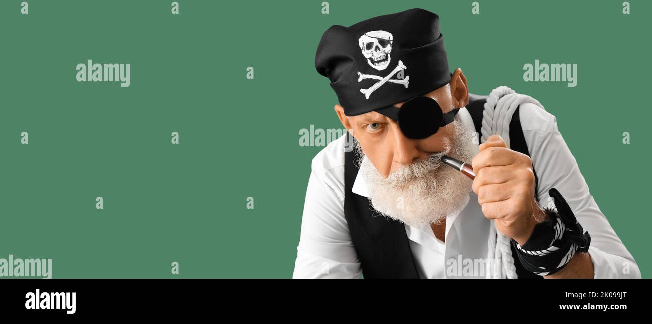 Mature pirate smoking pipe on green background with space for text ...
