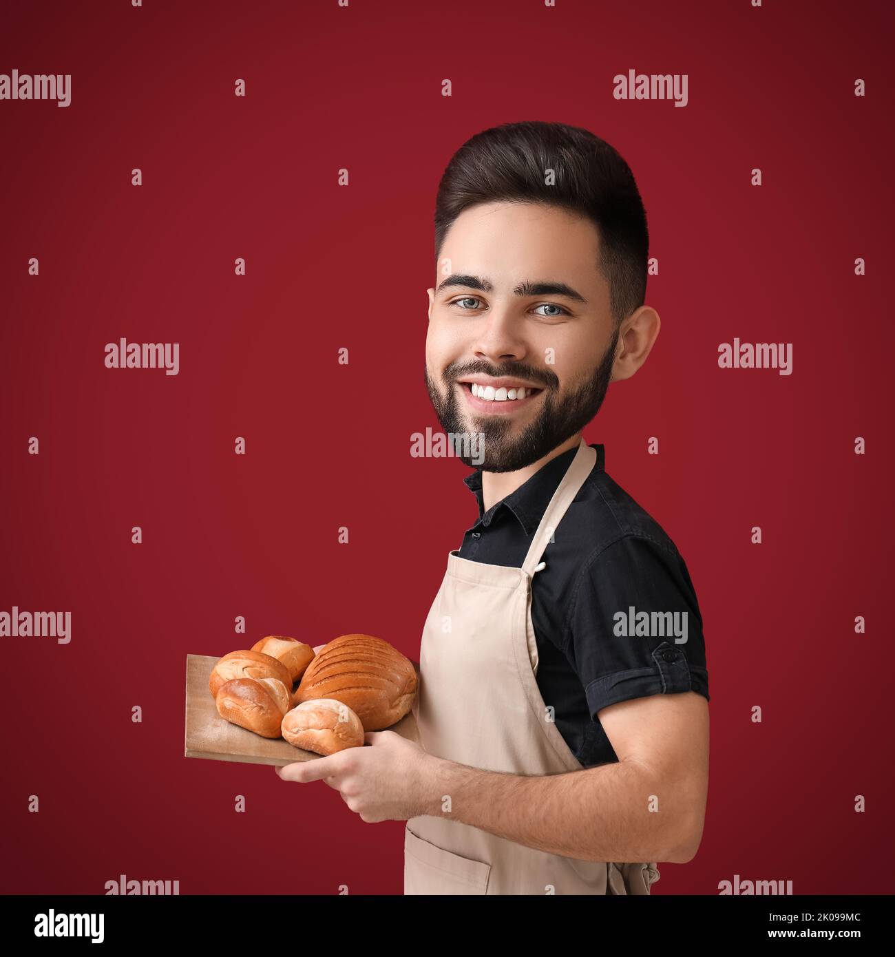 Funny male baker with big head on red background Stock Photo - Alamy