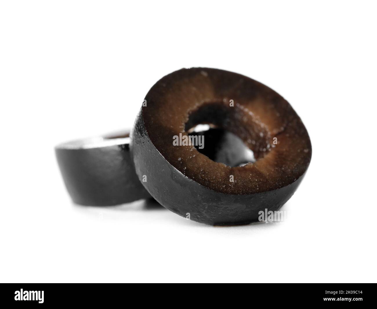 Slices of cut fresh black olives isolated on white background Stock ...