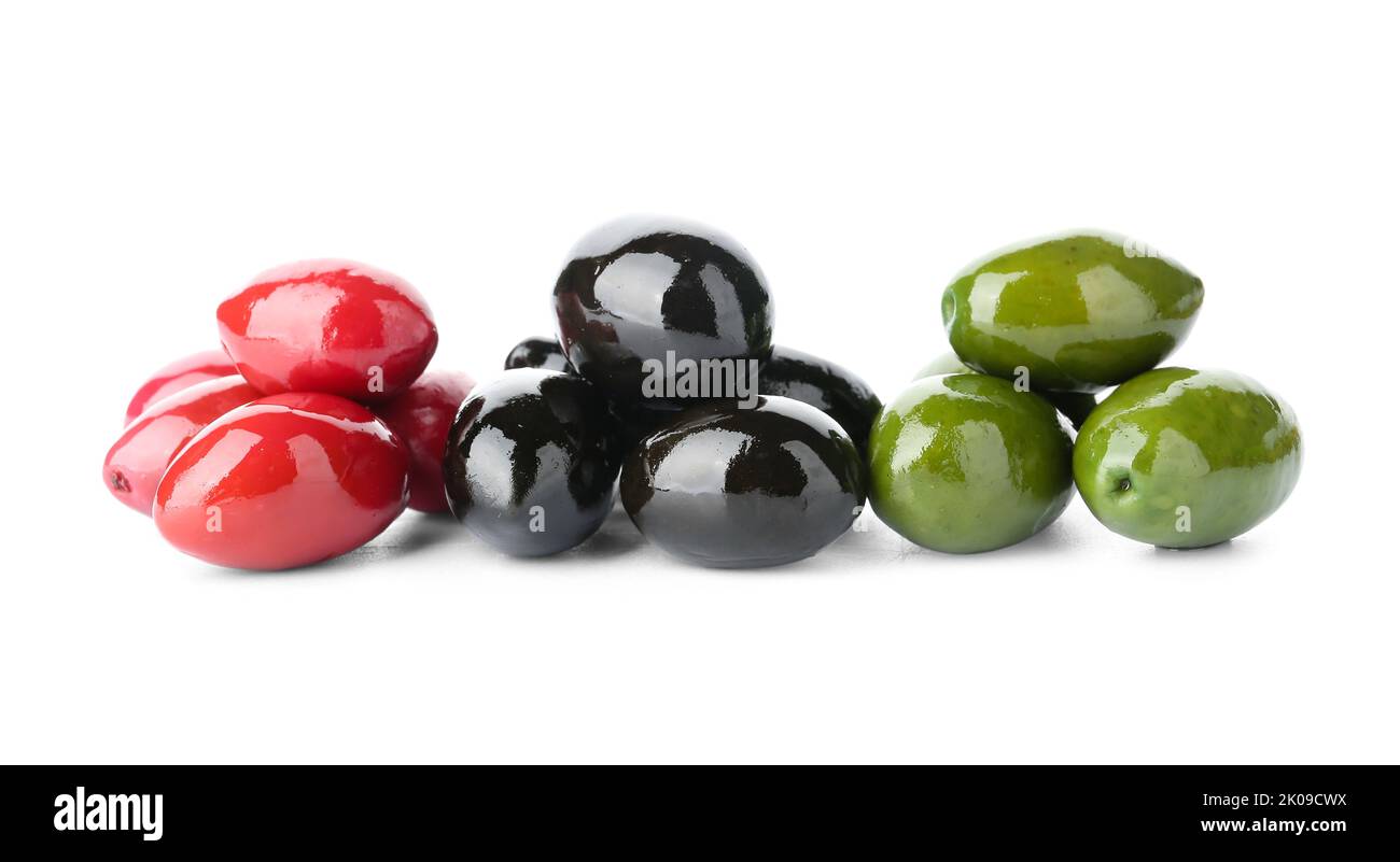 Heaps of tasty green, black and red olives on white background Stock ...