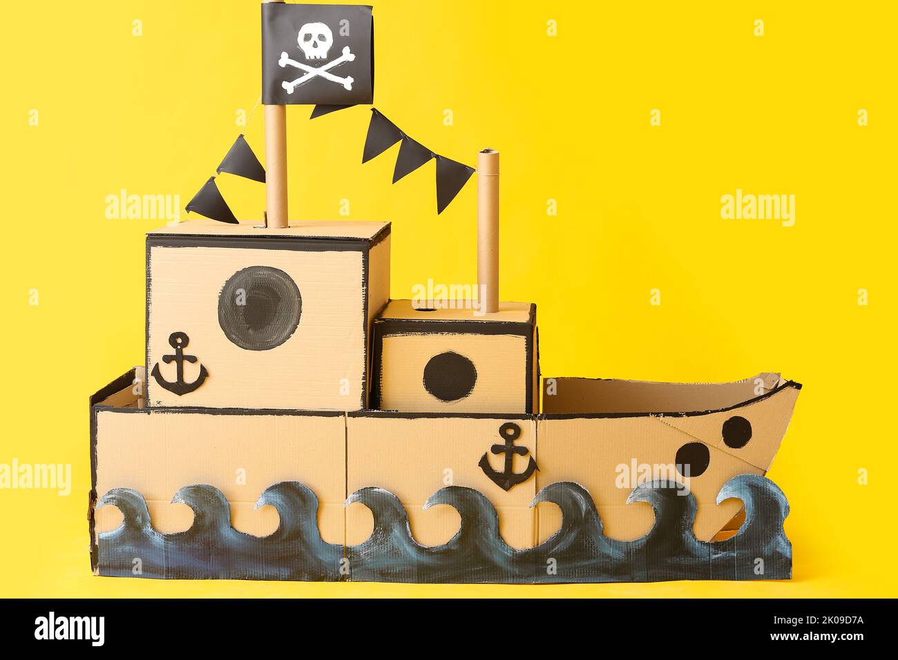 Cardboard pirate ship on yellow background Stock Photo - Alamy