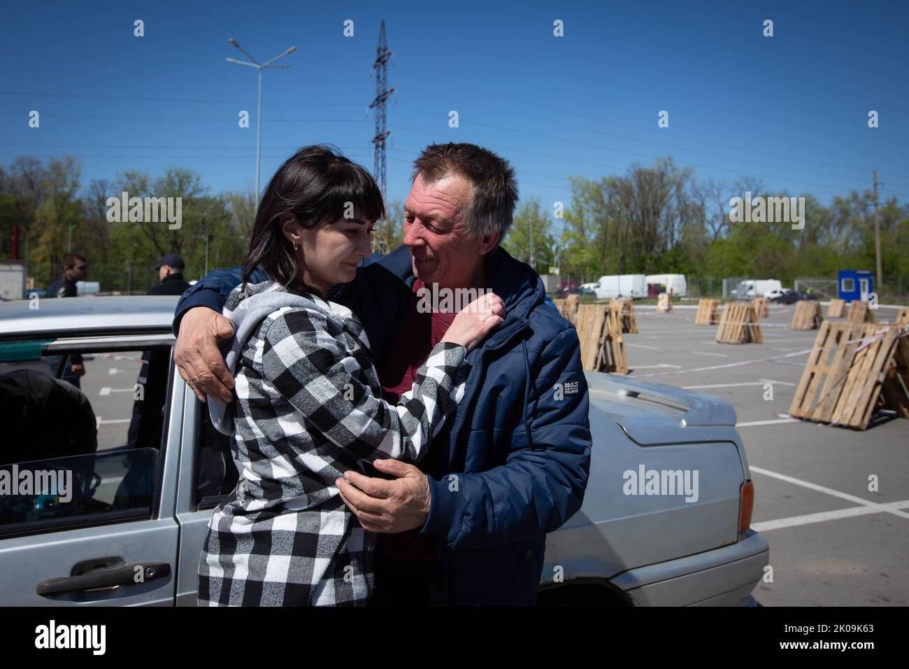 Family members embrace after being reunited at a refugee center in ...