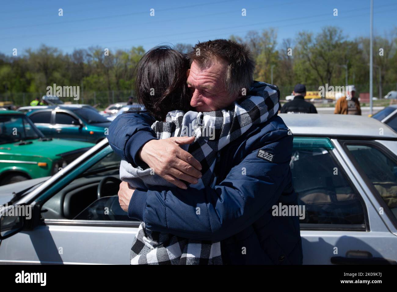 Family members embrace after being reunited at a refugee center in ...