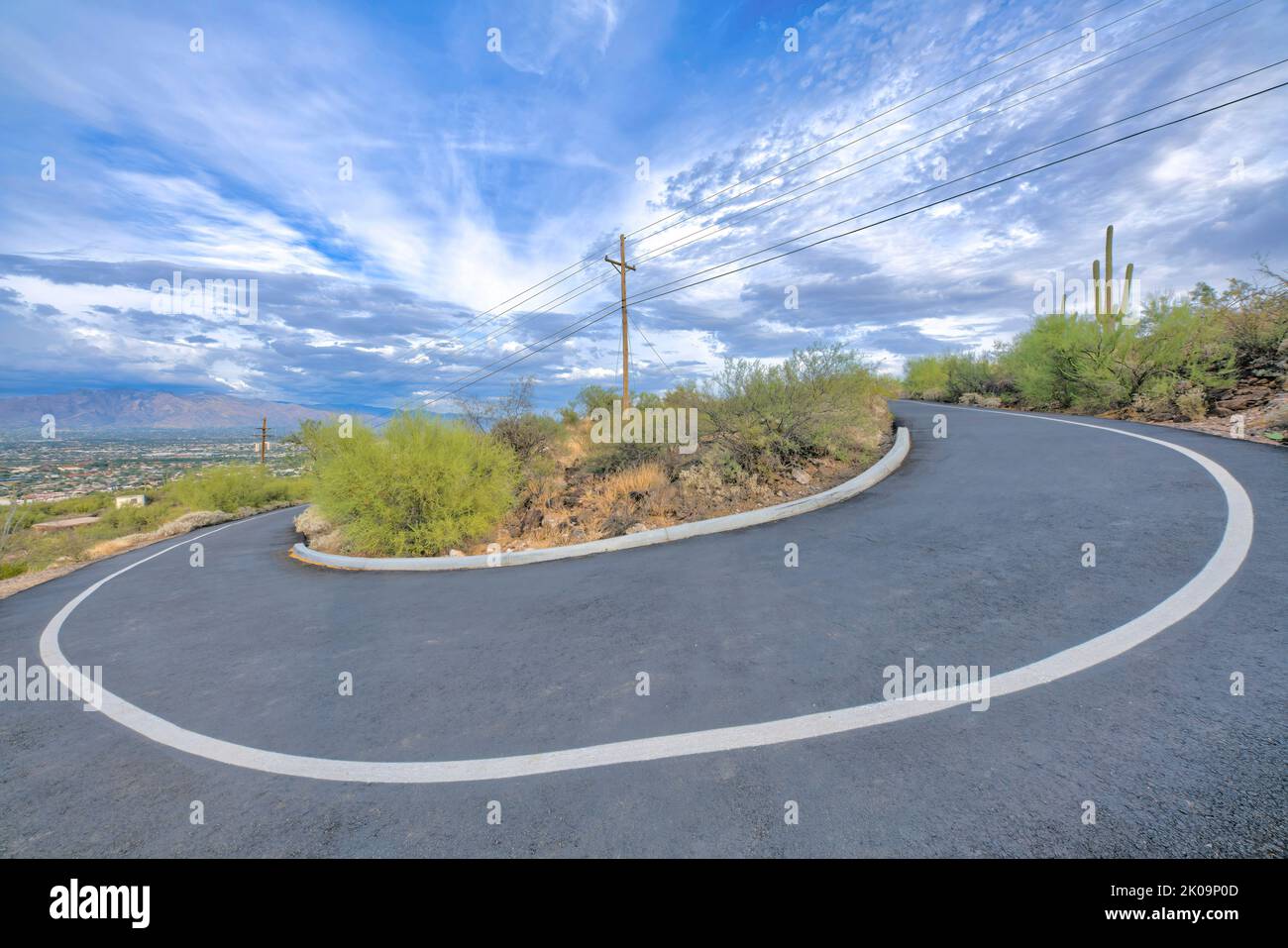 Downhill asphalt u-shaped bike path and walking pathway on a slope at ...