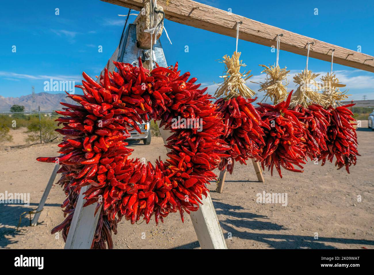 Hanging wreath of red chili peppers for sale on the side of the road at ...