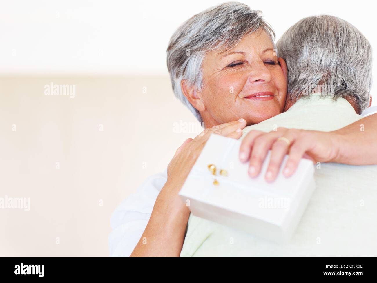 Attractive mature lady receiving anniversary hi-res stock photography ...