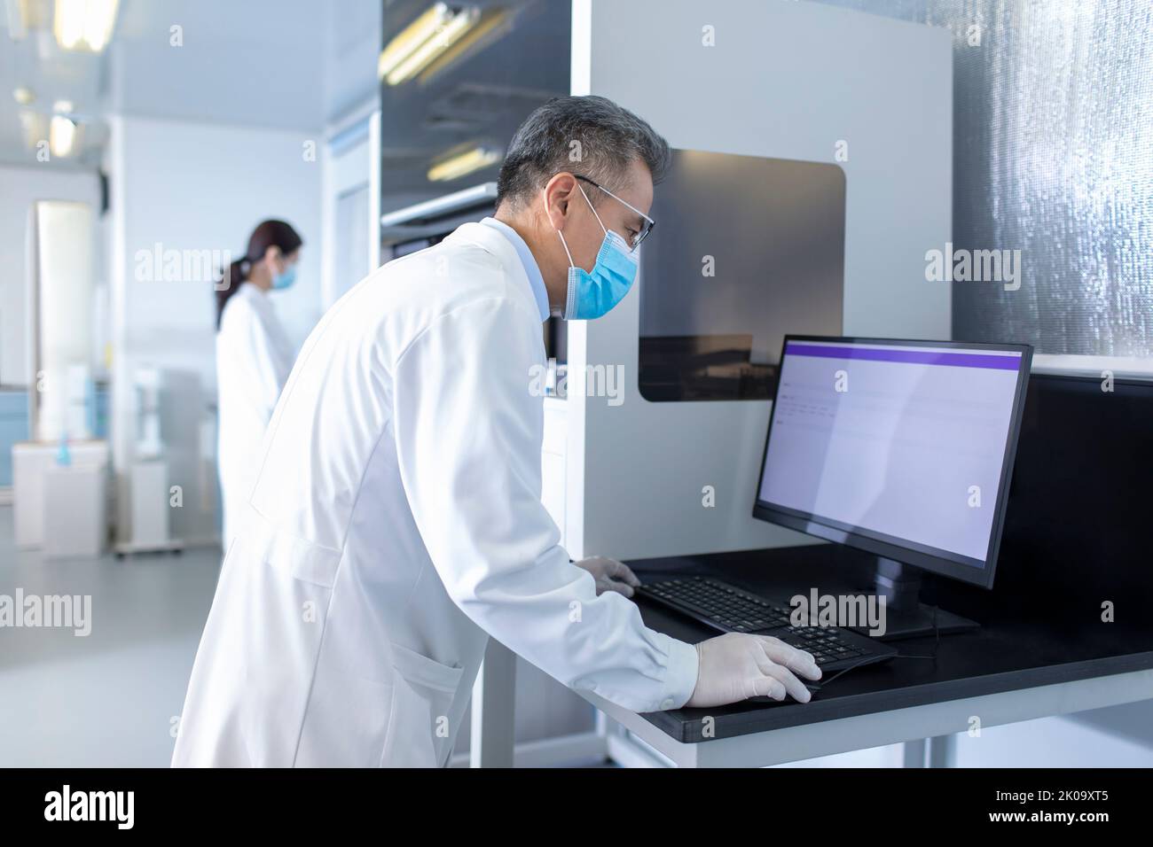 Two serious researchers using a computer in the laboratory Stock Photo ...