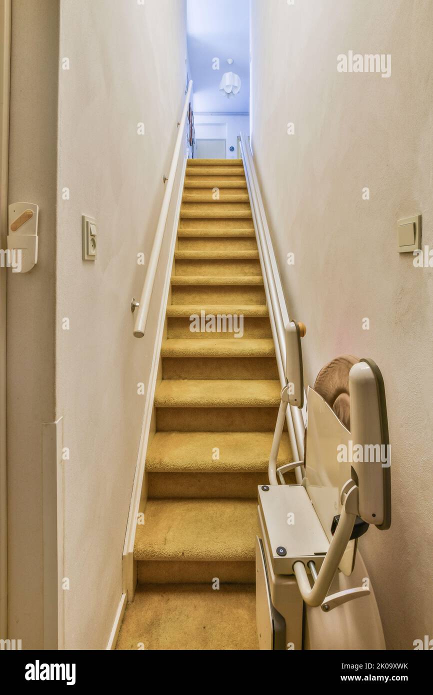 White hallway with stairway leading to second floor of modern luxury ...