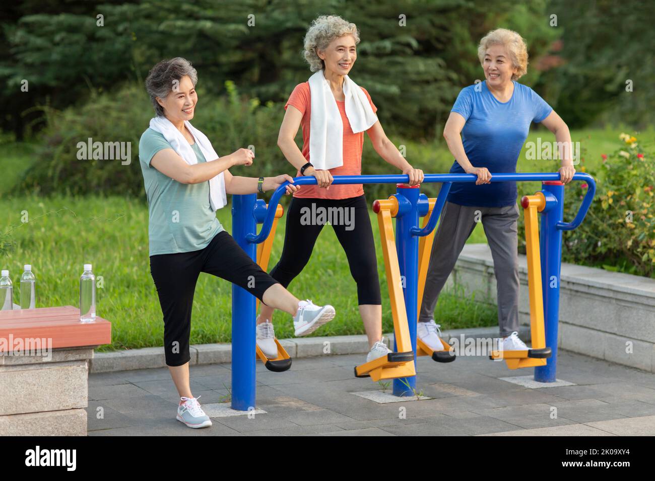 Happy senior Chinese friends exercising in park Stock Photo - Alamy
