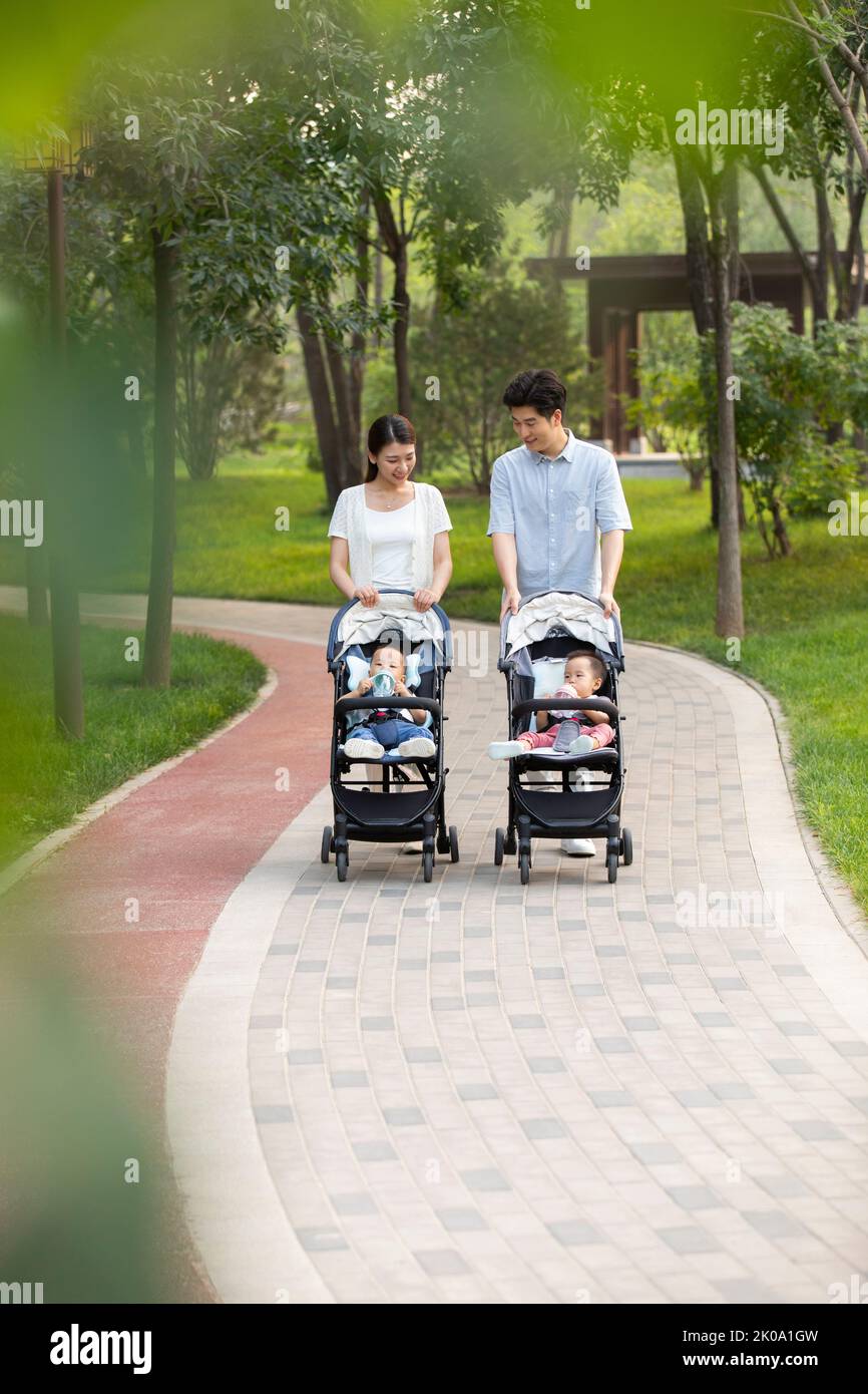 Young Chinese parents with twin babies in strollers Stock Photo - Alamy