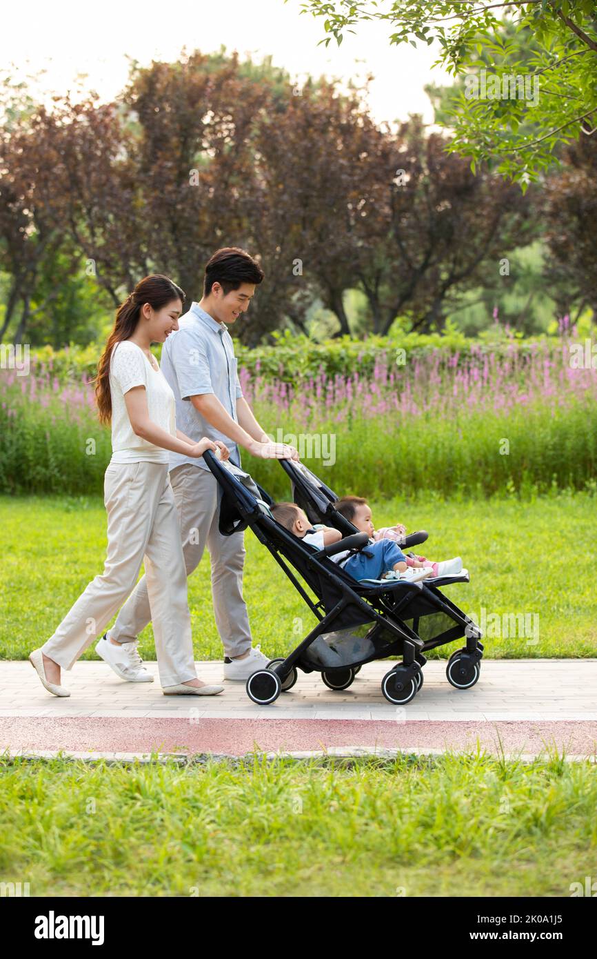 Young Chinese parents with twin babies in strollers Stock Photo - Alamy