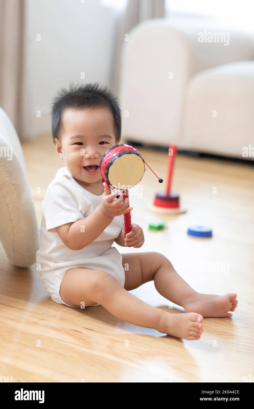 Cute Chinese baby playing with toys at home Stock Photo - Alamy
