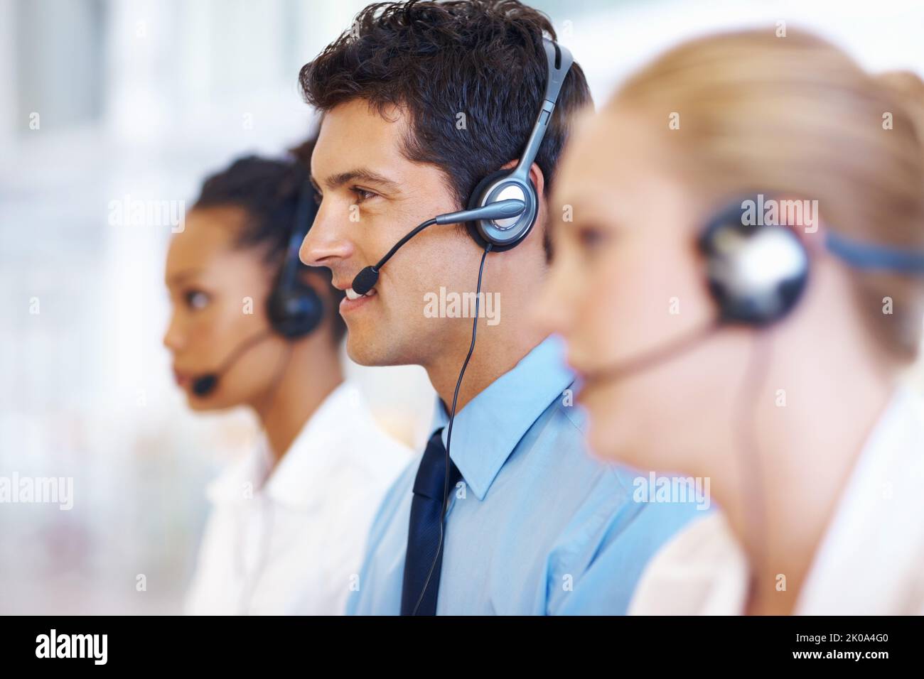Call center operators. Portrait of male and female operators with ...