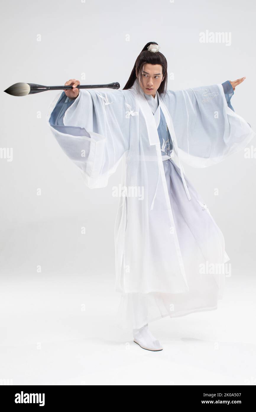 Young Chinese man in ancient costume writing calligraphy Stock Photo ...