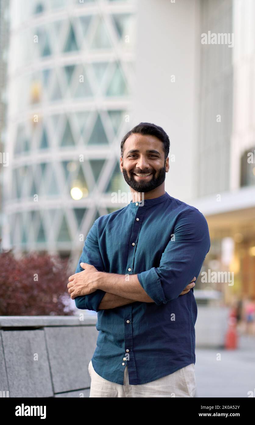 Confident happy indian business man looking at camera outdoor vertical ...