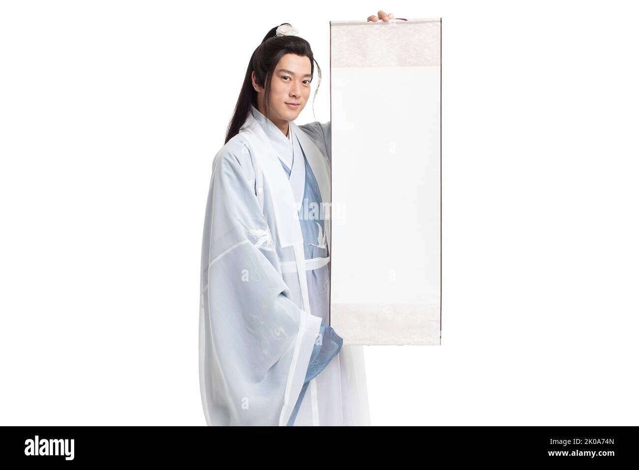 Young Chinese man in ancient costume holding a blank scroll Stock Photo ...