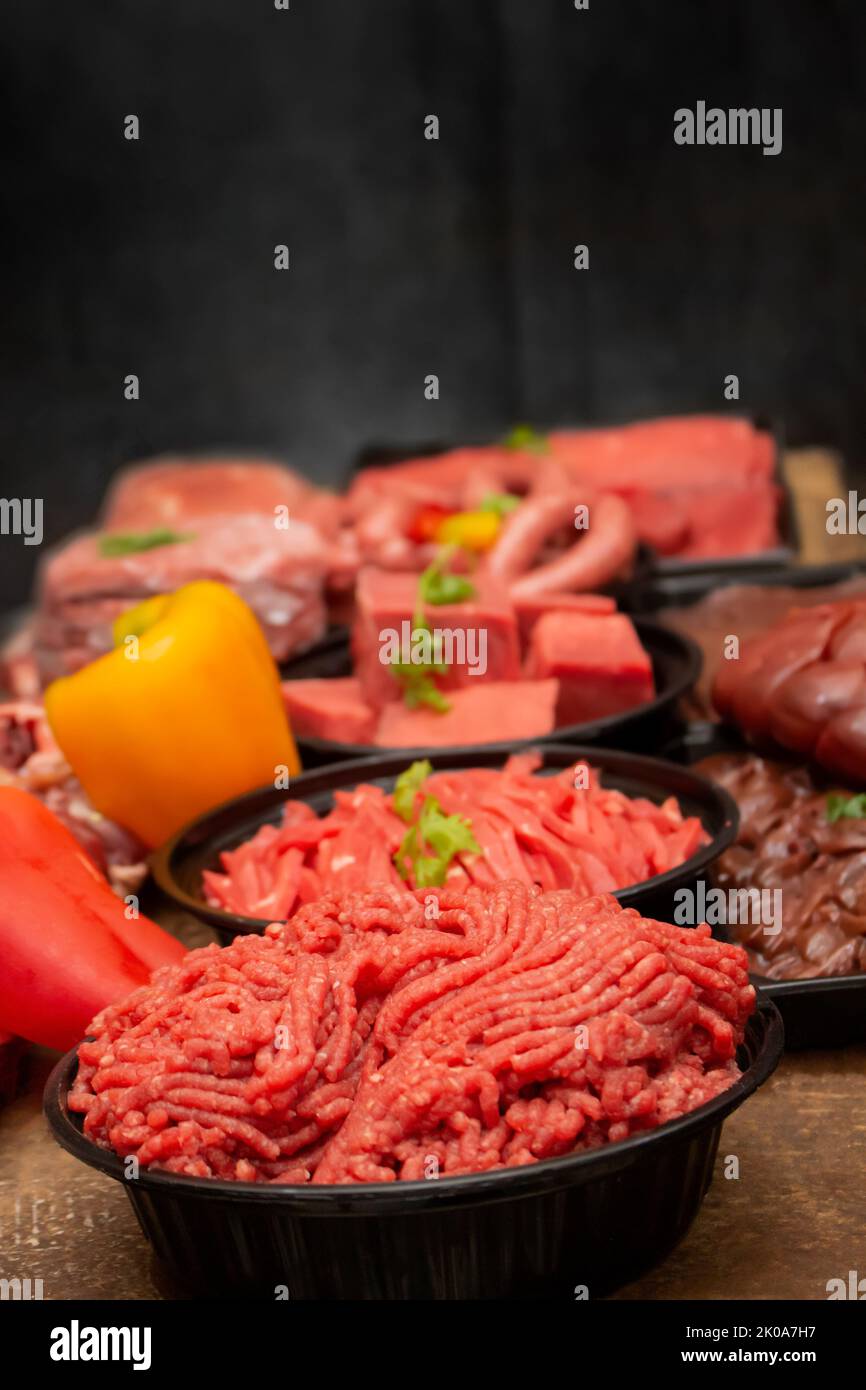 Assorted Raw Beef Meats on Table with Black Background Side View Stock ...