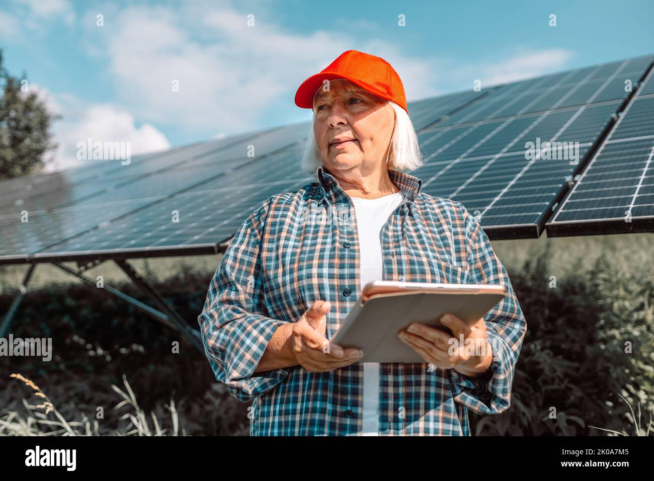 Senior engineer is checking with tablet an operation of sun and ...