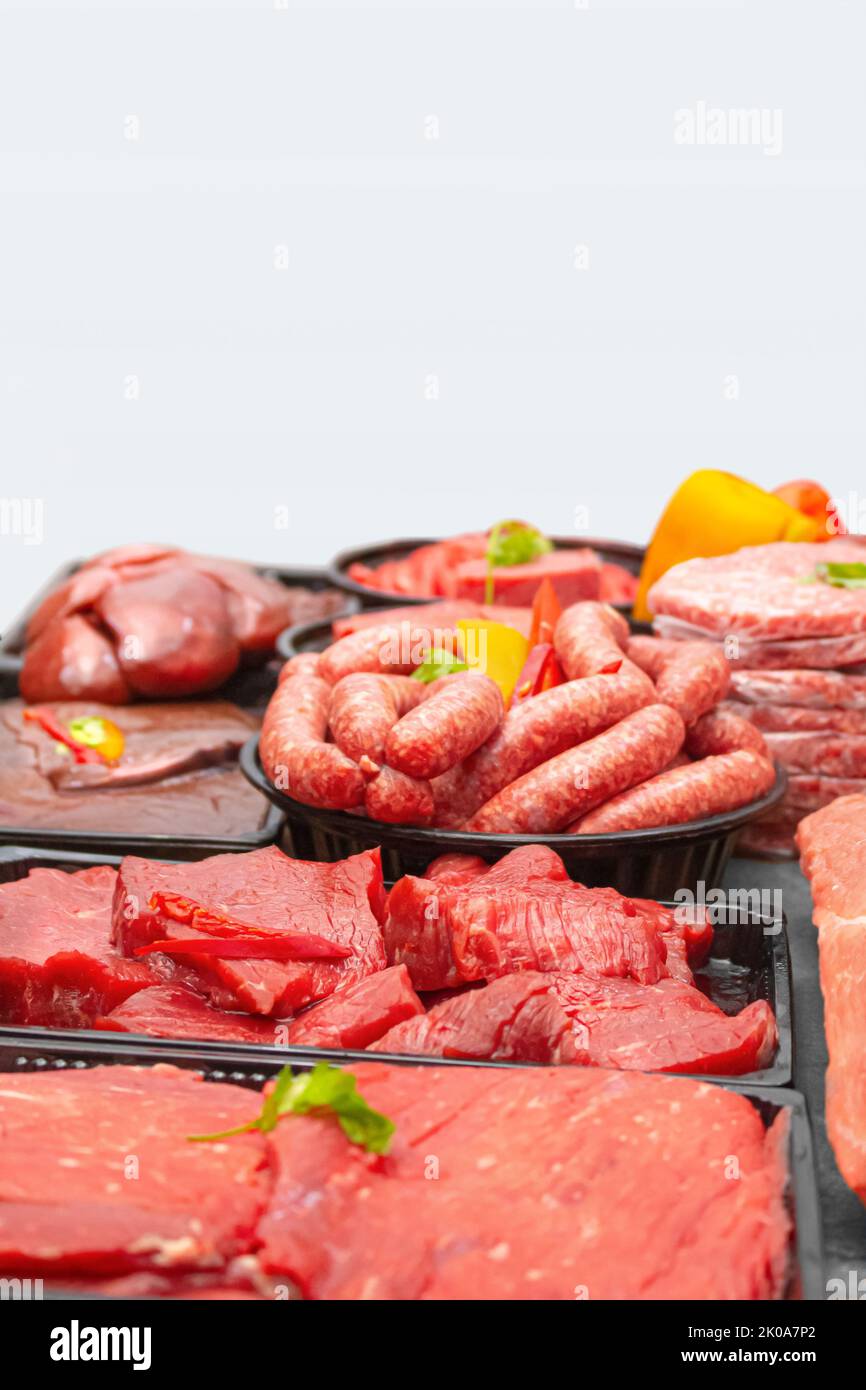 Side View of Assorted Fresh Beef Cuts and Sausages in Black Trays ...