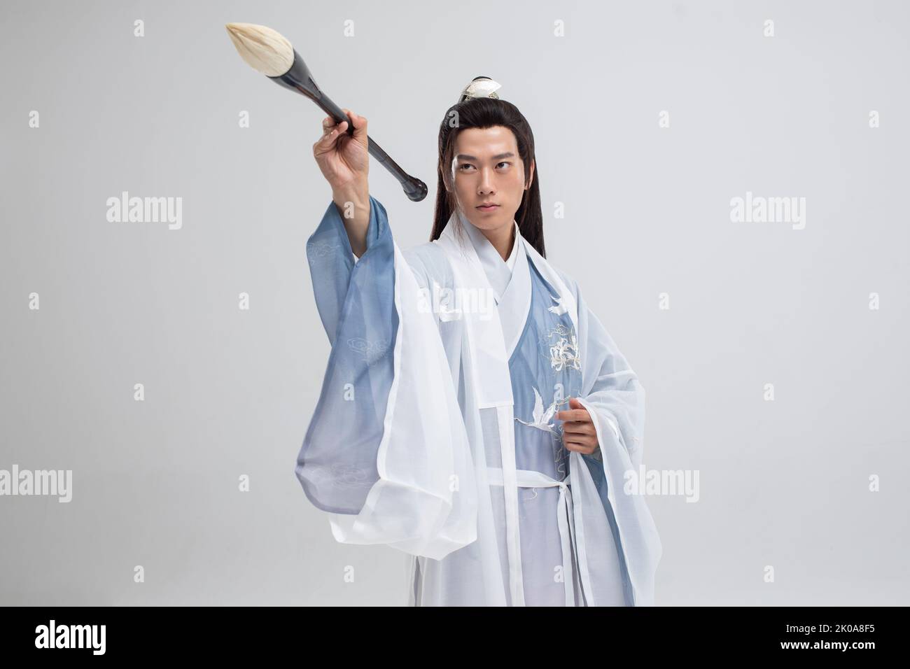 Young Chinese man in ancient costume writing calligraphy Stock Photo ...