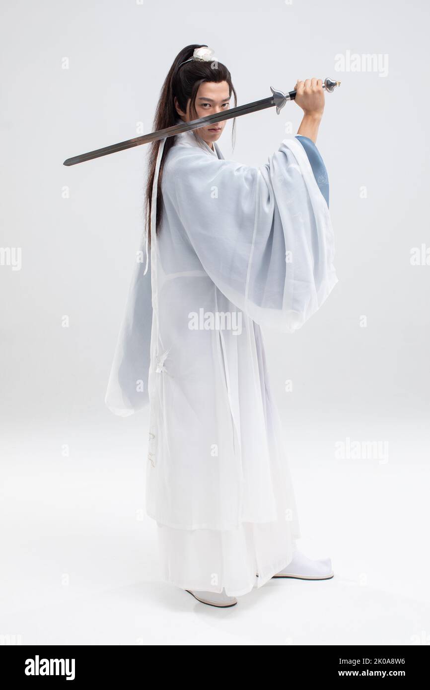 Young Chinese swordsman in ancient costume Stock Photo - Alamy