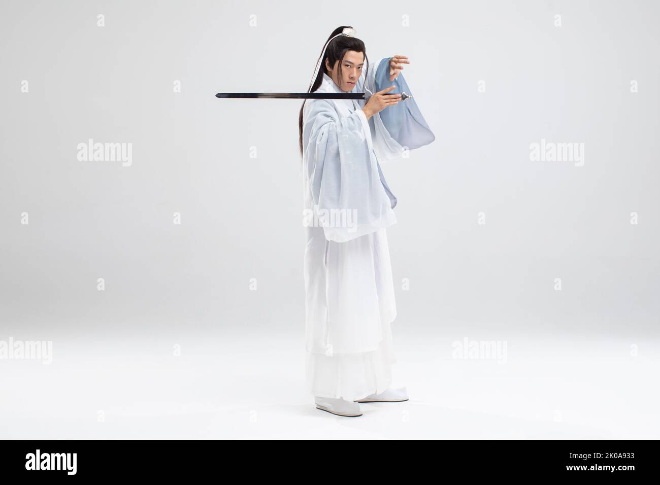 Young Chinese swordsman in ancient costume Stock Photo - Alamy