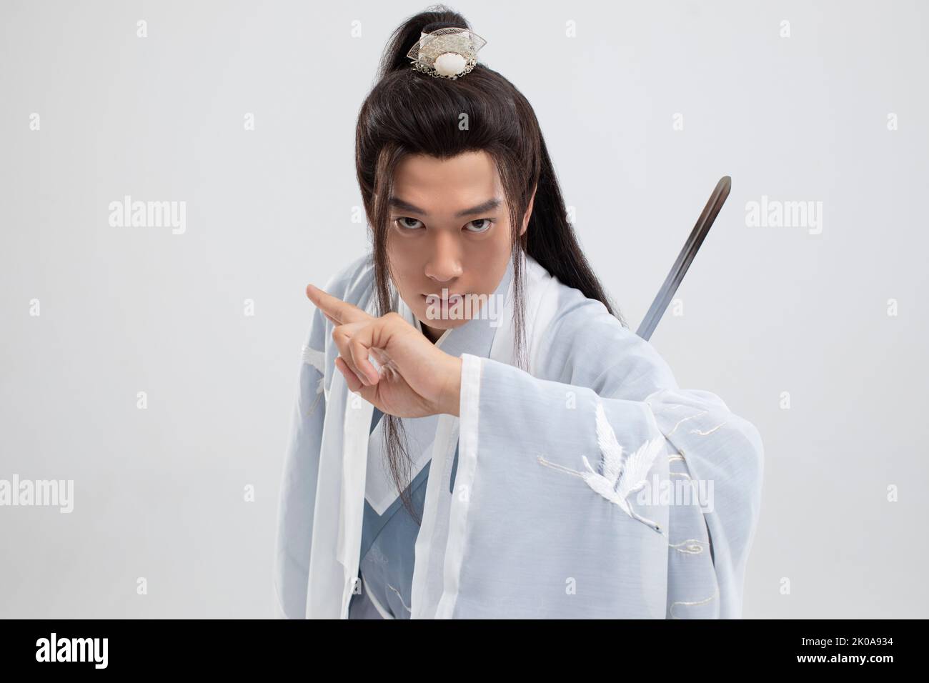 Young Chinese swordsman in ancient costume Stock Photo - Alamy