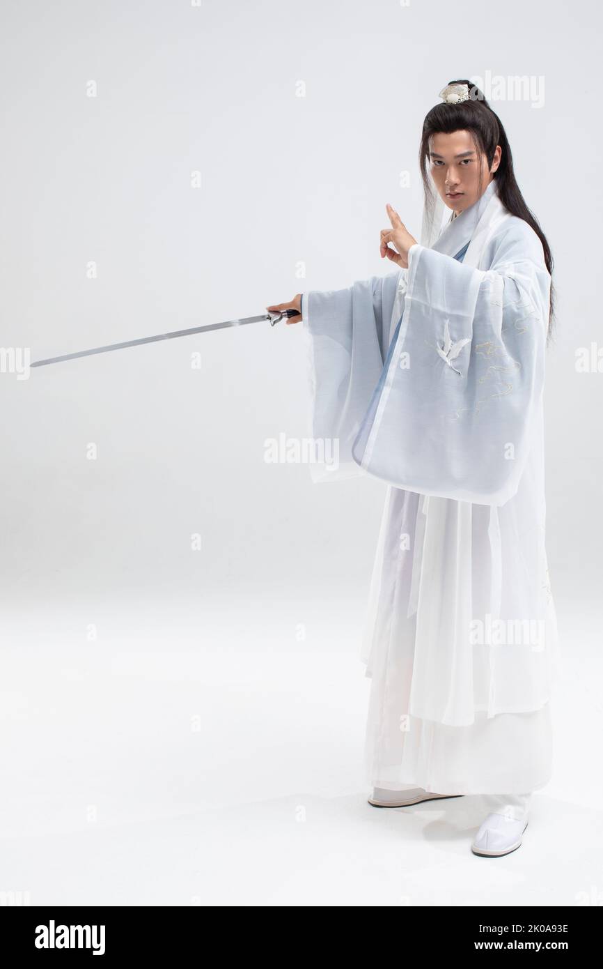 Young Chinese swordsman in ancient costume Stock Photo - Alamy