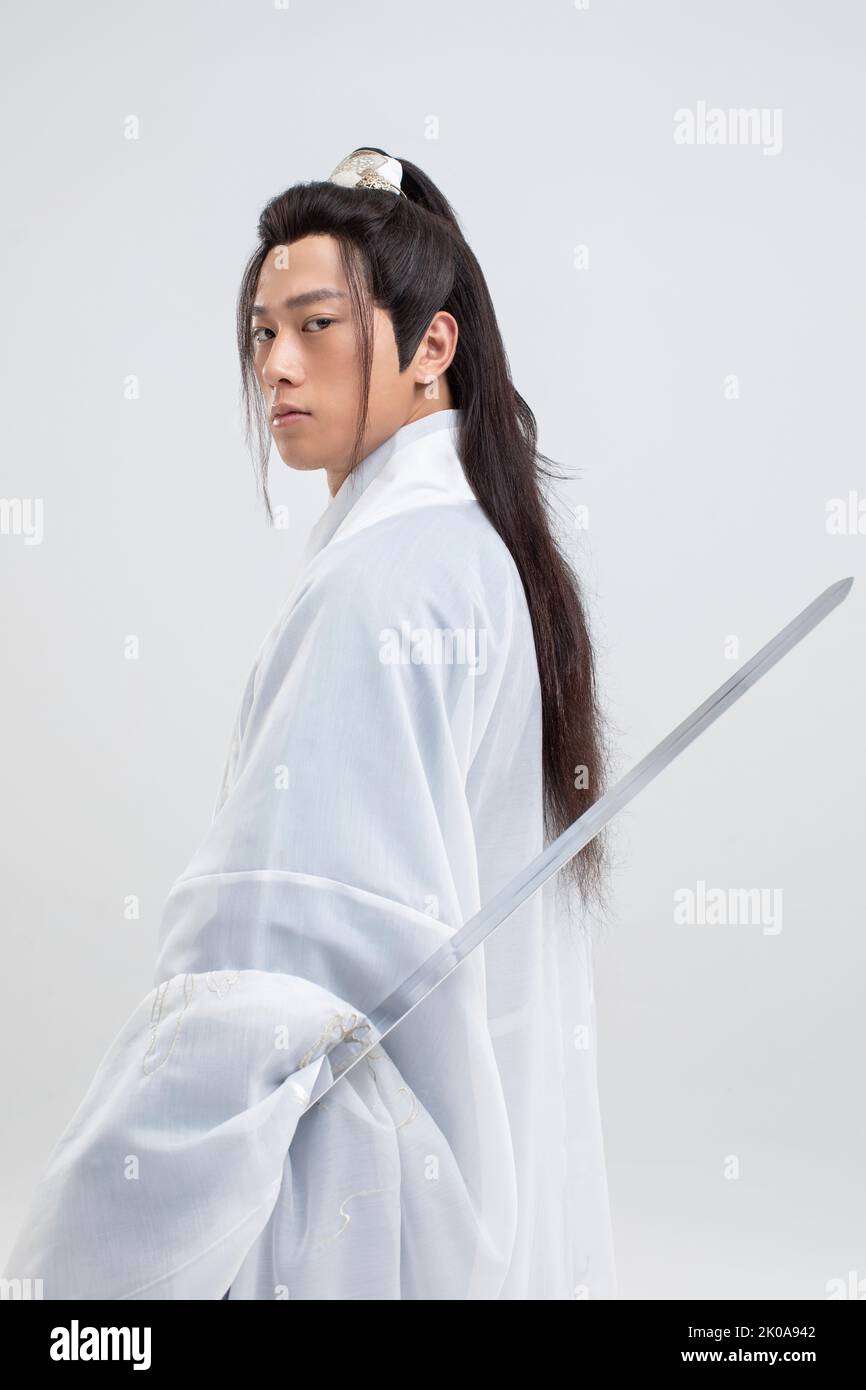 Young Chinese swordsman in ancient costume Stock Photo - Alamy