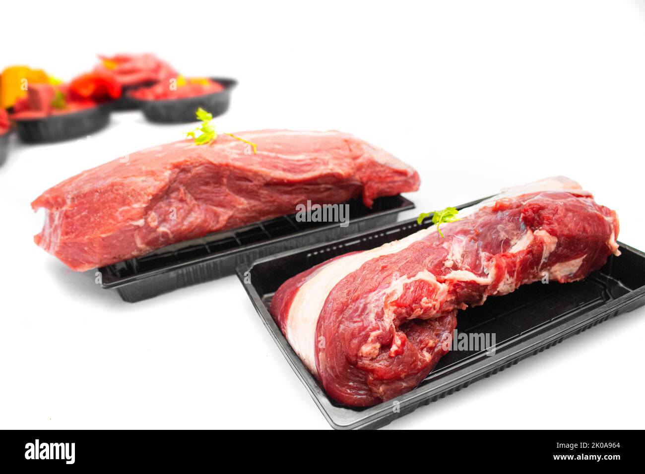 Side View of Fresh Beef Cuts in Black Trays with Background Ingredients ...