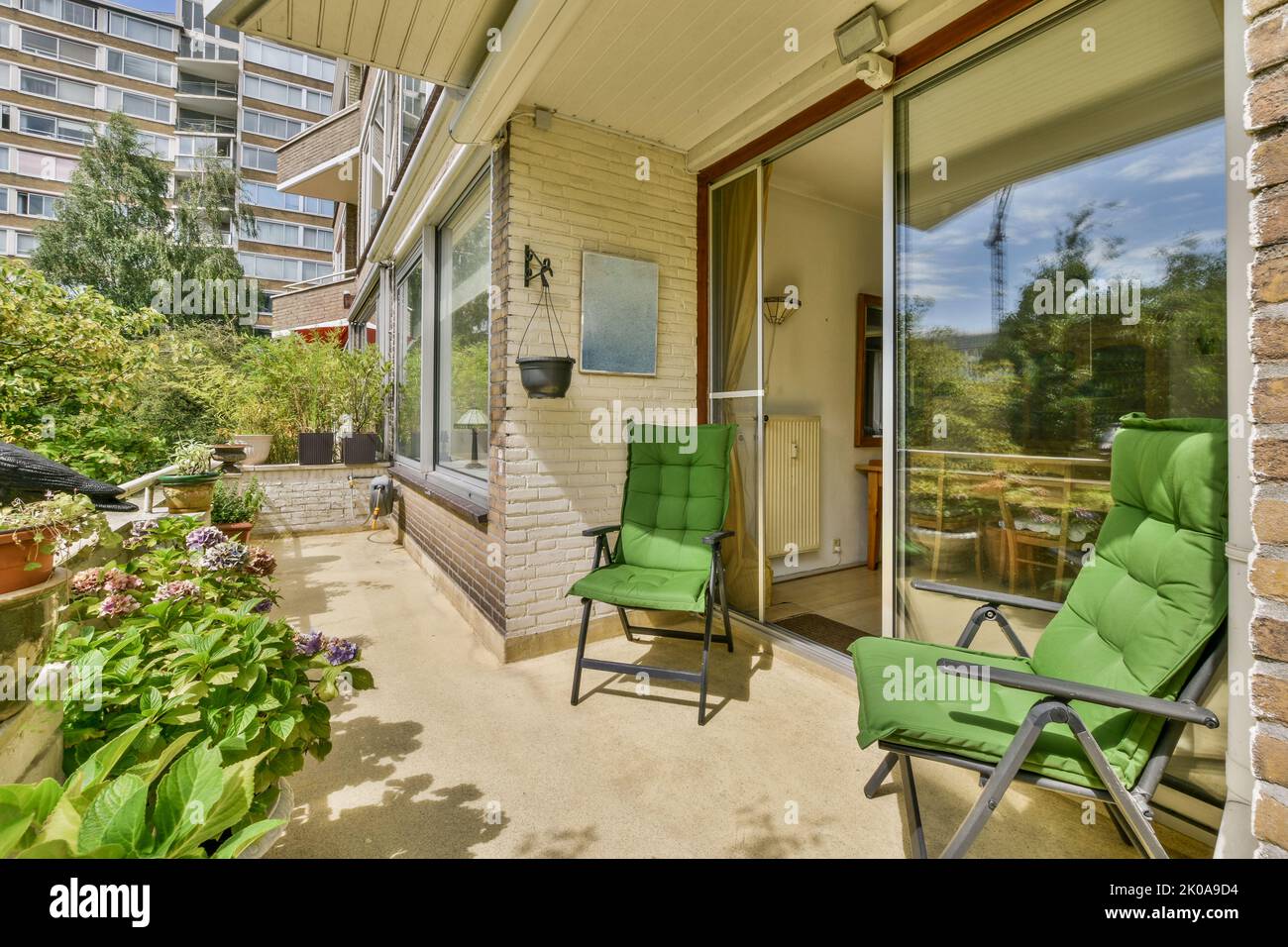 Simple small balcony with small garden near window Stock Photo - Alamy
