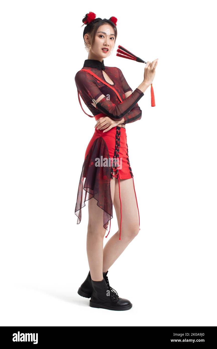 Cheerful young Chinese woman holding a fan Stock Photo - Alamy