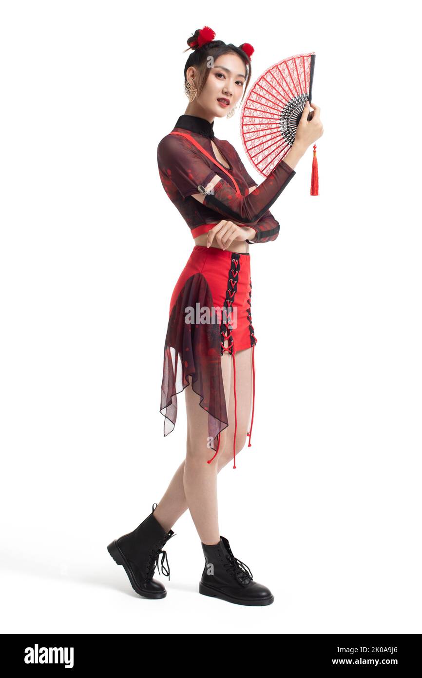 Cheerful young Chinese woman holding a fan Stock Photo - Alamy