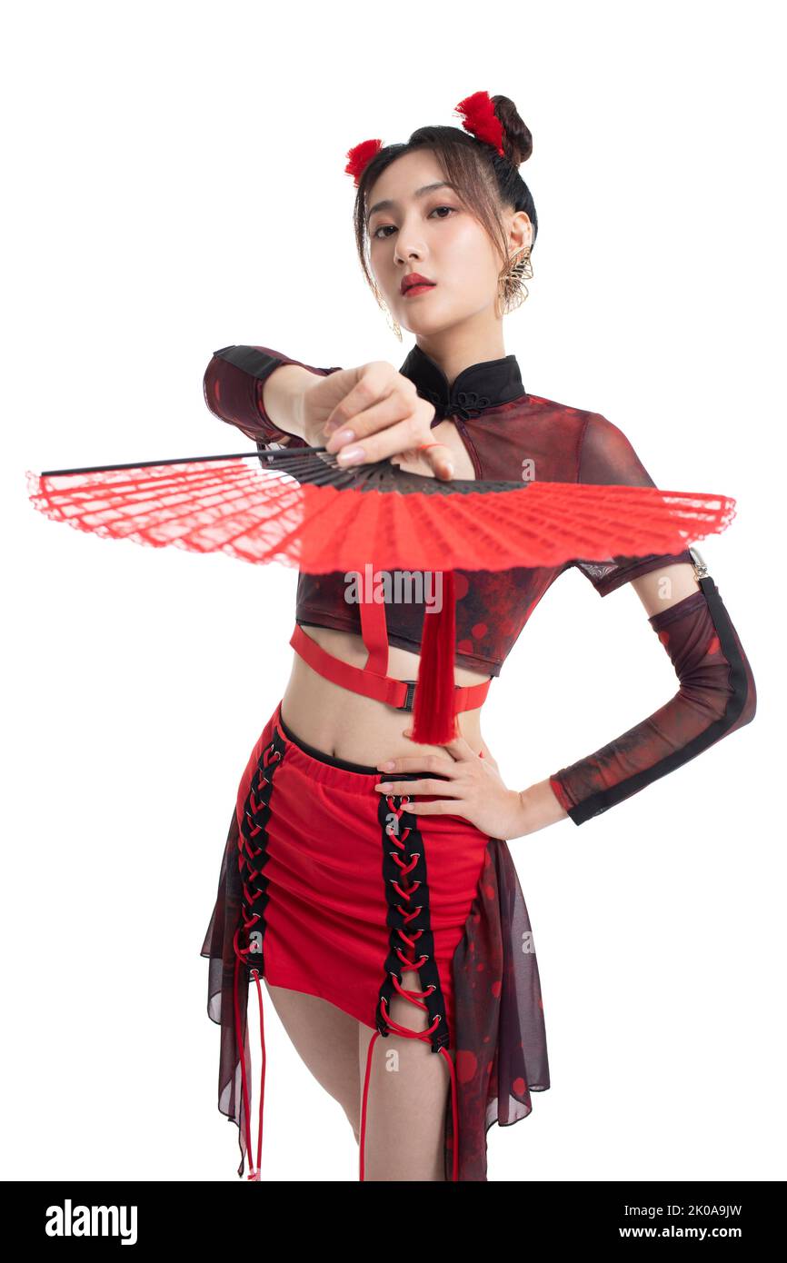 Cheerful young Chinese woman holding a fan Stock Photo - Alamy