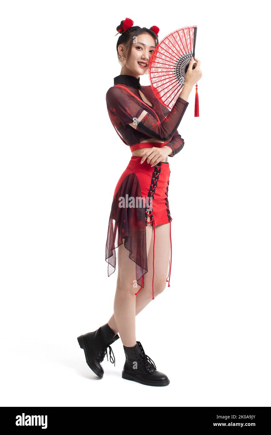 Cheerful young Chinese woman holding a fan Stock Photo - Alamy