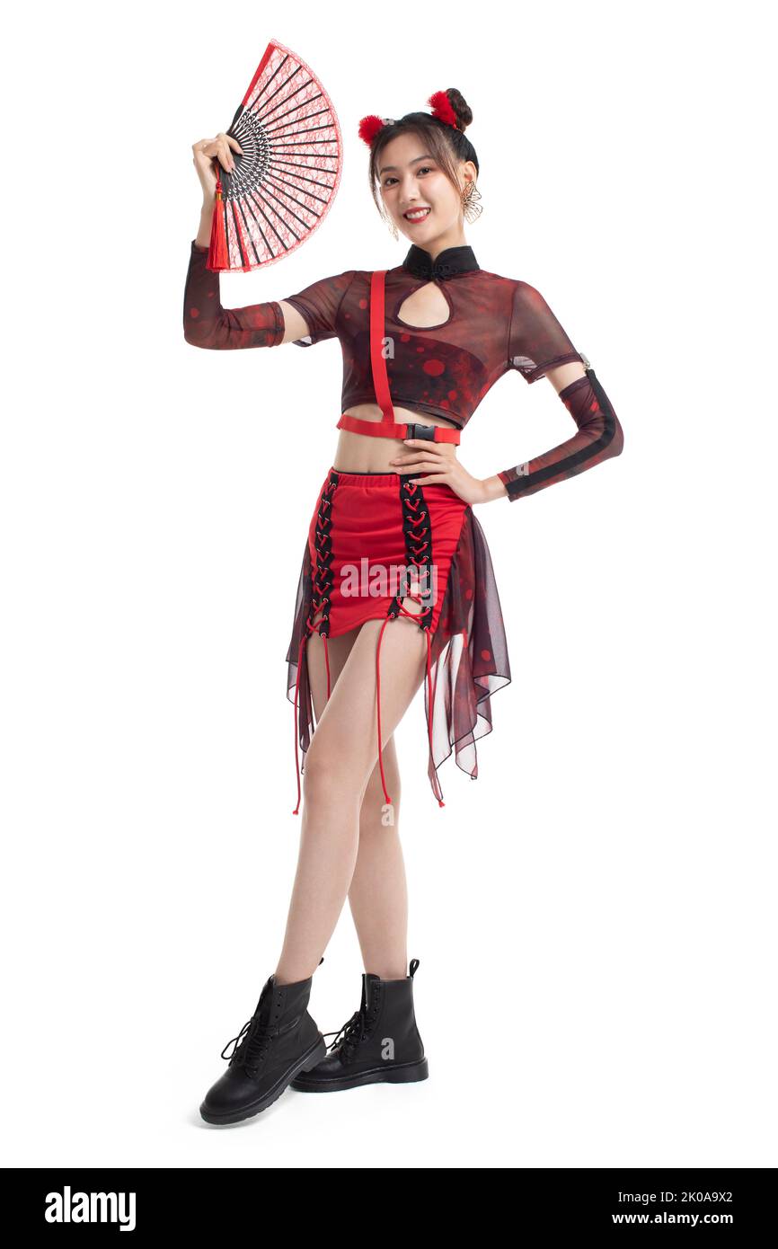 Cheerful young Chinese woman holding a fan Stock Photo - Alamy