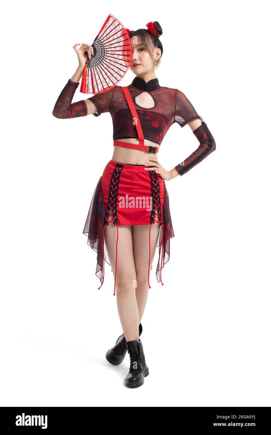 Cheerful young Chinese woman holding a fan Stock Photo - Alamy