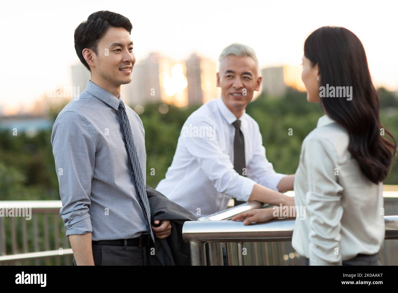 Confident Chinese business people talking outdoors Stock Photo - Alamy