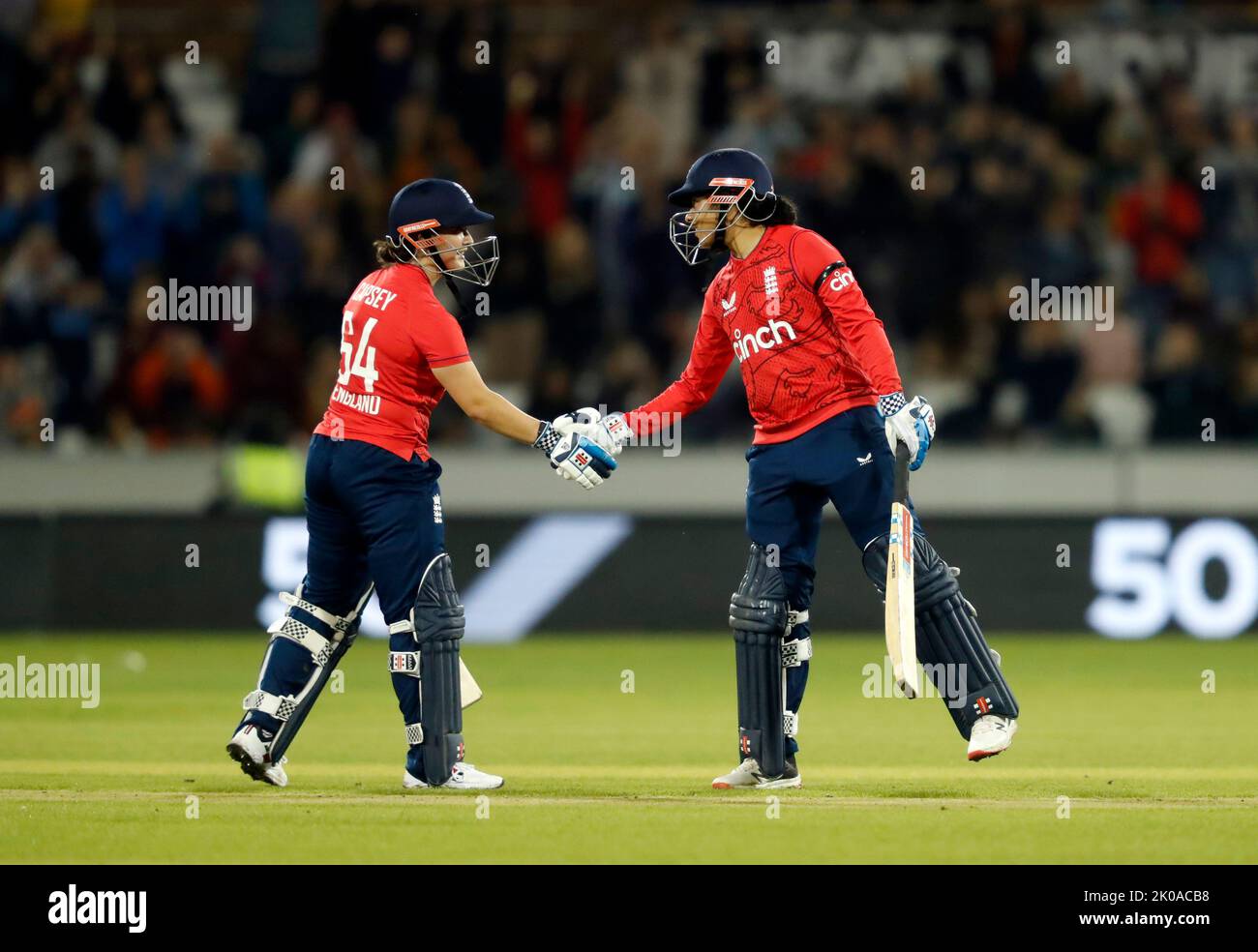 England's Sophia Dunkley (right) celebrates 50 runs with batting ...