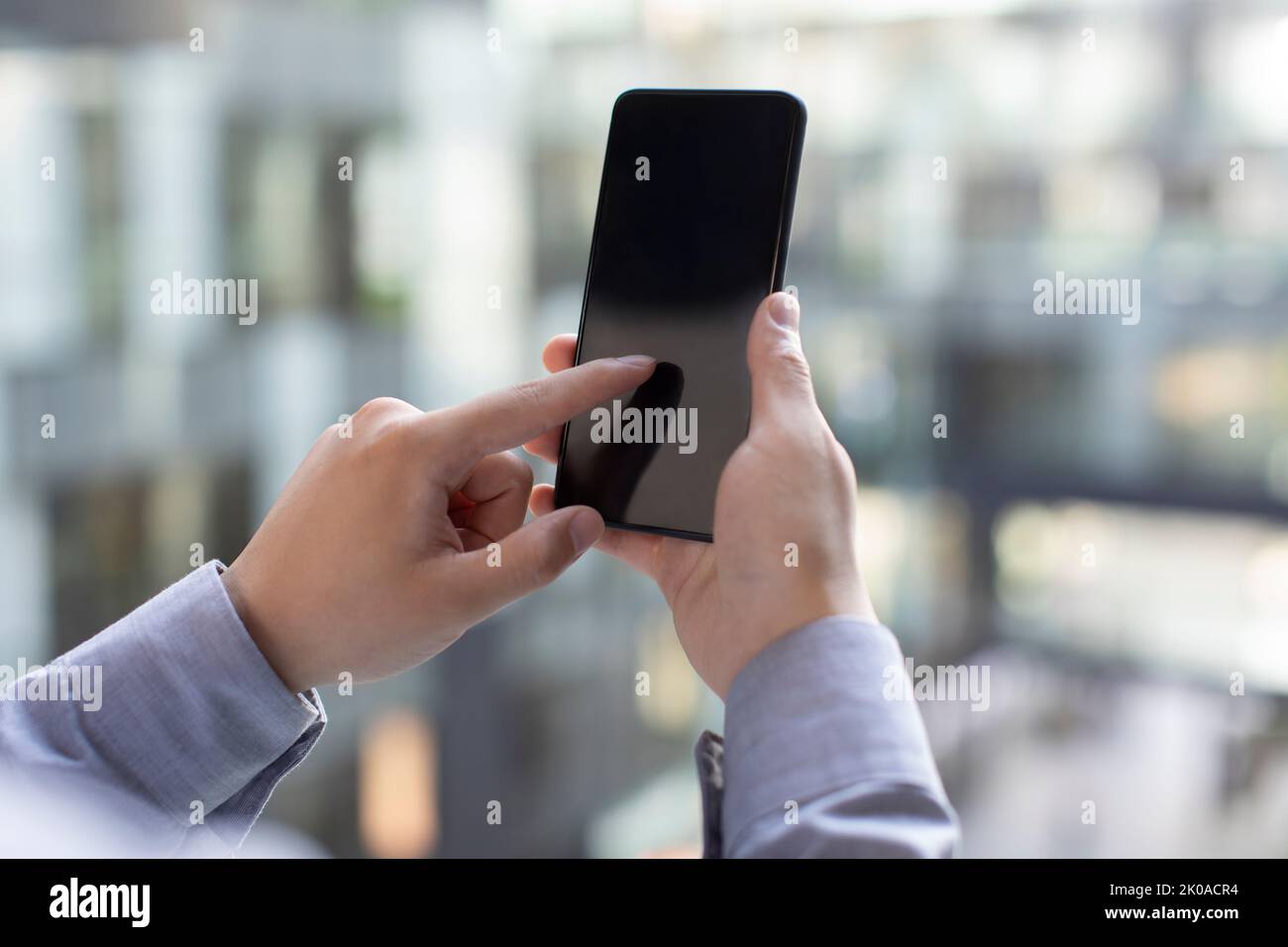 Young Chinese businessman using smart phone Stock Photo - Alamy