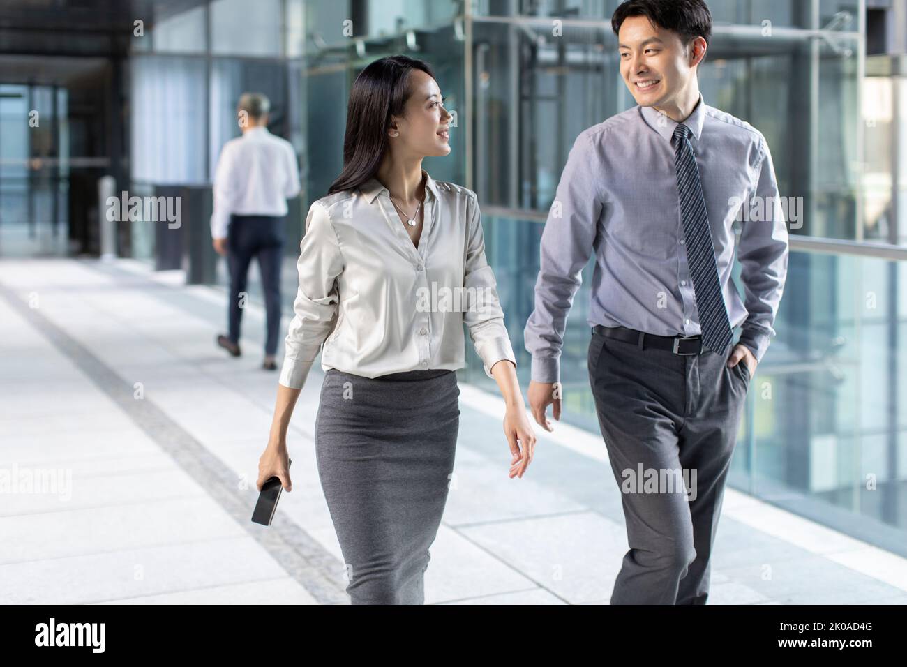 Confident Chinese business people walking Stock Photo - Alamy