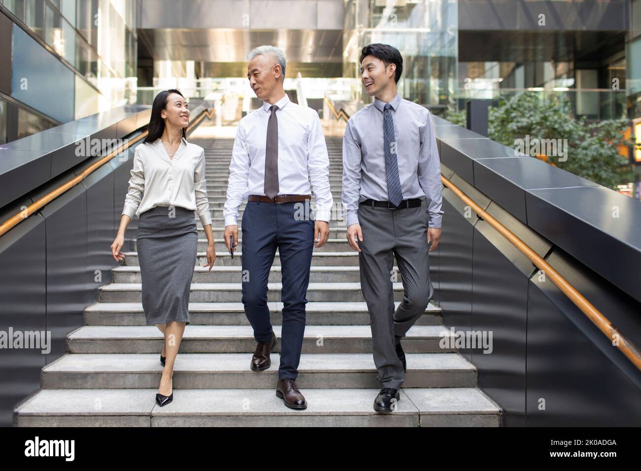 Chinese business people walking outdoors Stock Photo - Alamy