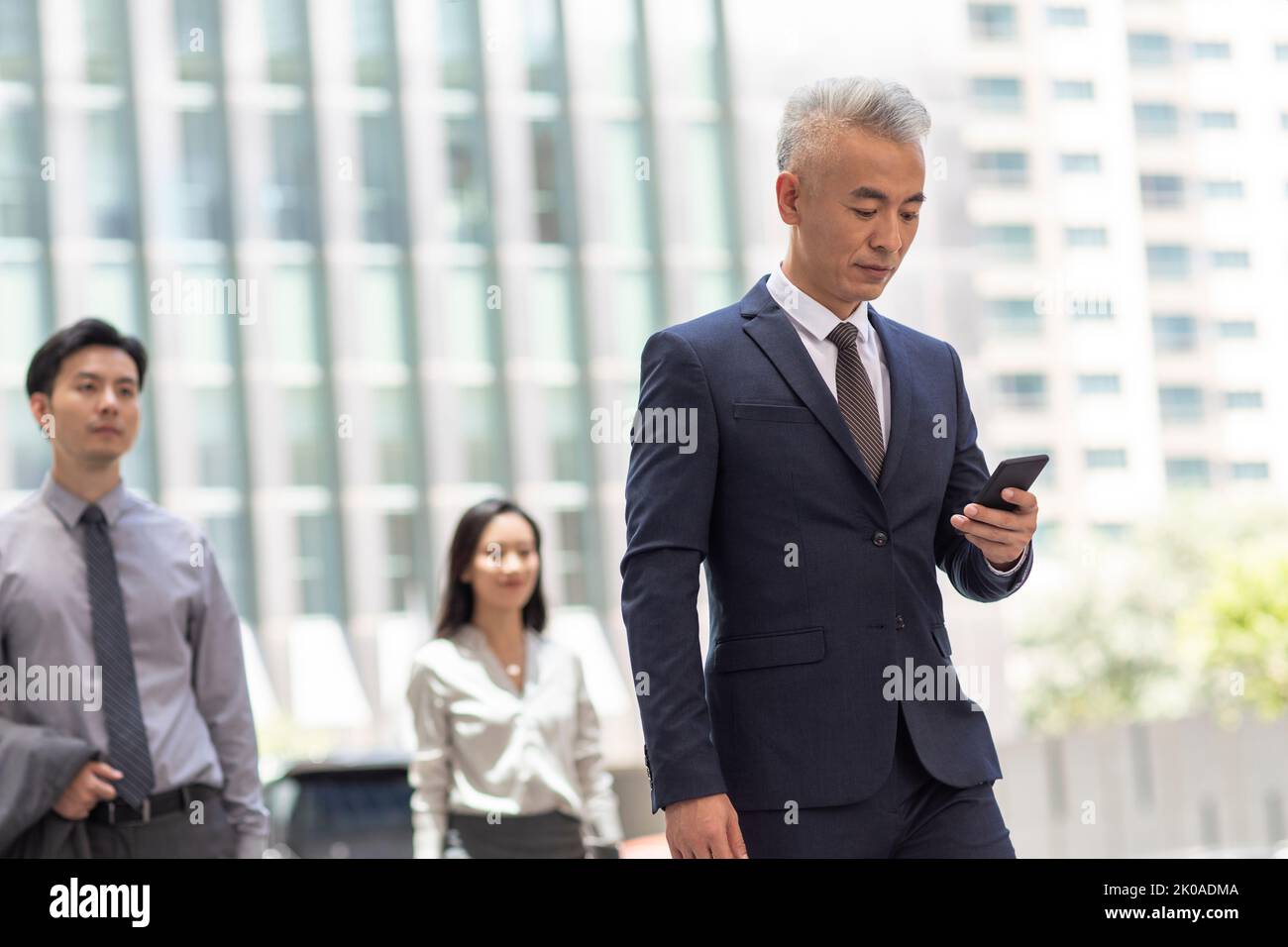 Confident businessman businesswoman walking downtown hi-res stock ...