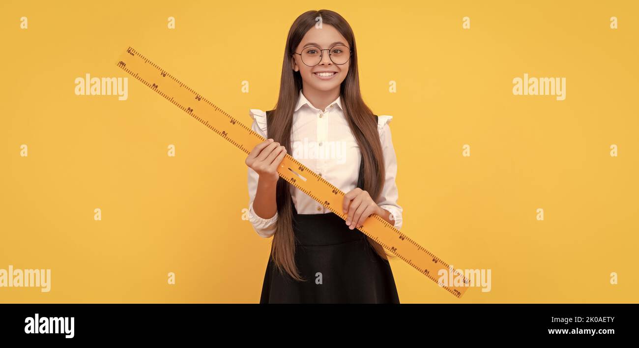 happy nerd kid in school uniform and glasses hold mathematics ruler for ...