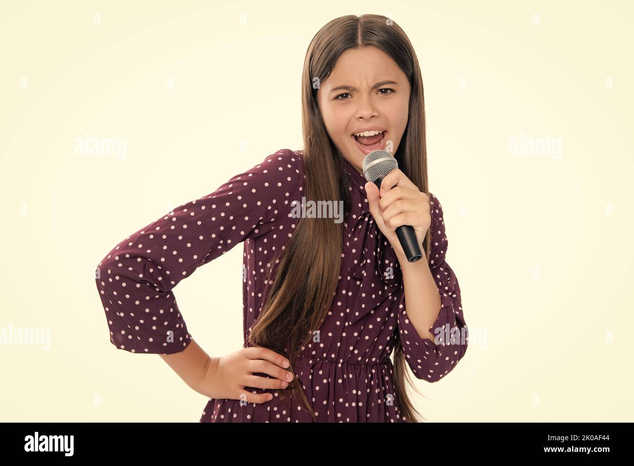 Teenager singing with a microphone. Karaoke singer. Teen girl sings. Child girl musician loud ...