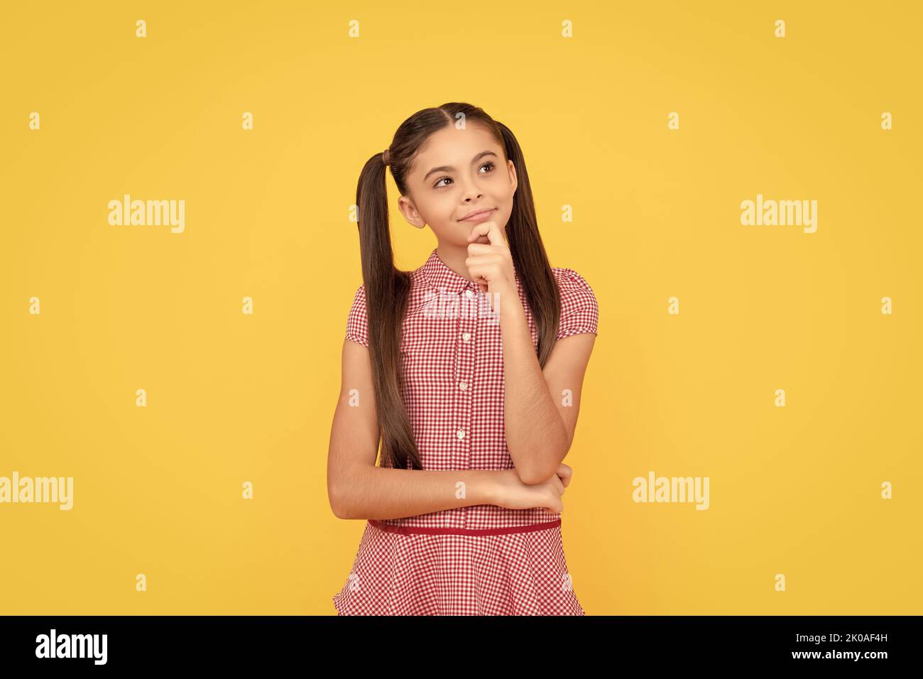 Start thinking big. Thoughtful girl yellow background. School age child ...