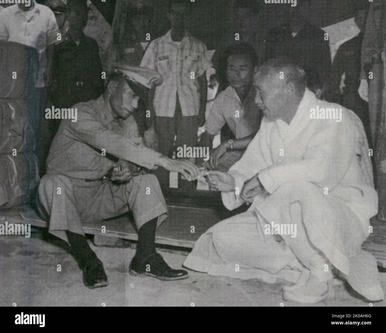 South Korean leader, Park Chung Hee, drinks rice wine, at a paddy field ...