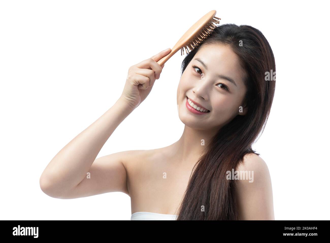 Beautiful young Chinese woman combing long hair Stock Photo - Alamy
