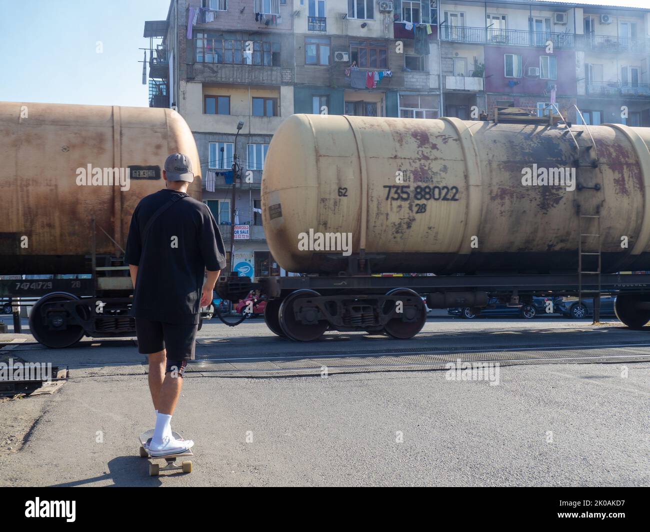 Railroad in the city. A guy on a skateboard drove up to the tanks. Tank ...