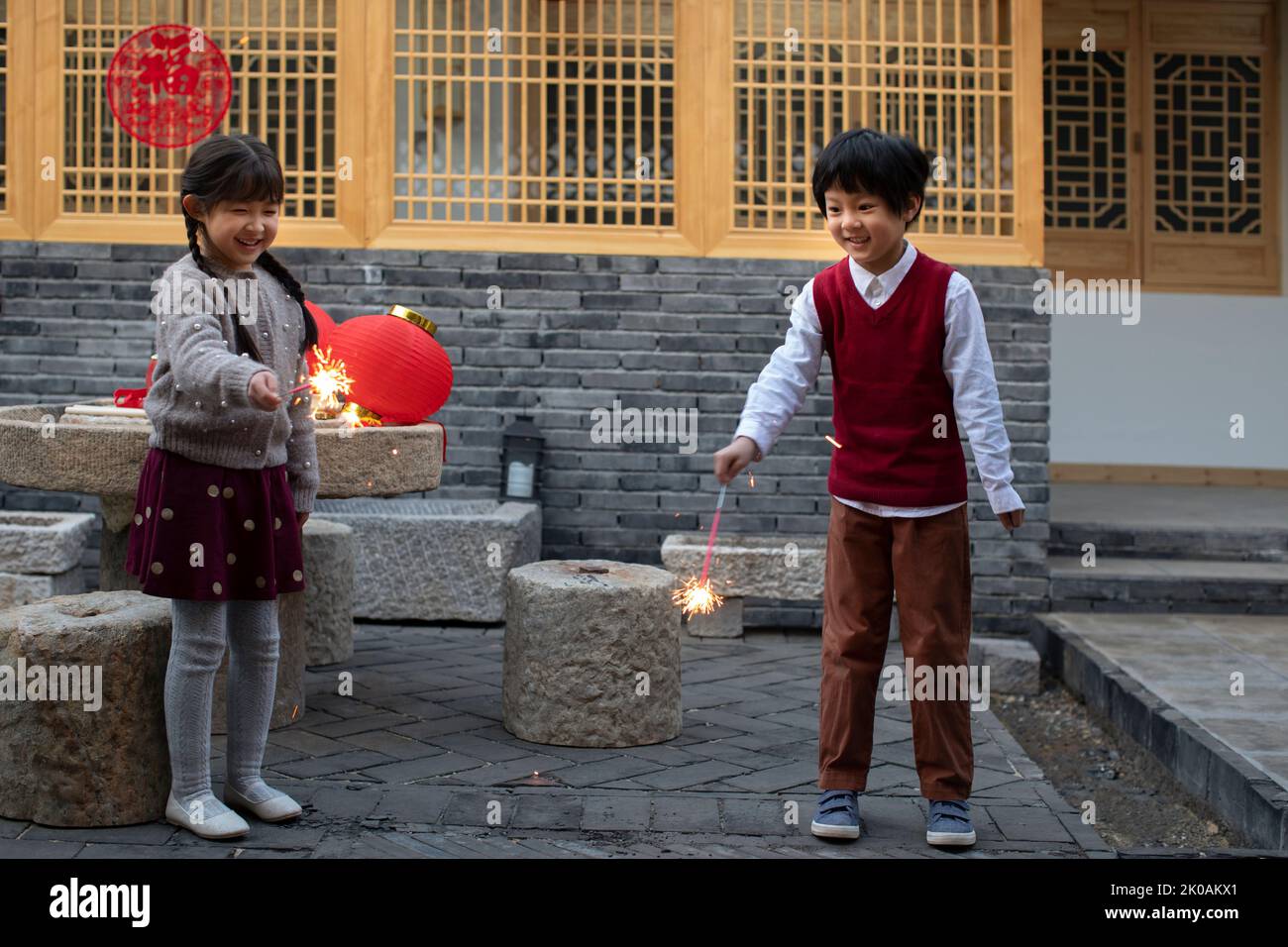 Happy children celebrating Chinese new year Stock Photo - Alamy